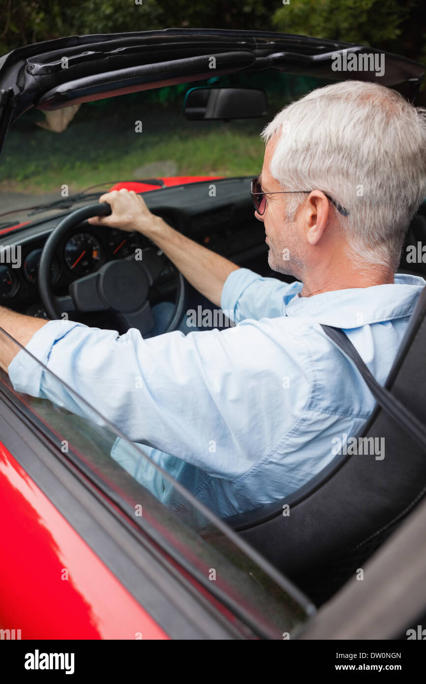 Handsome man driving his red convertible Stock Photo - Alamy