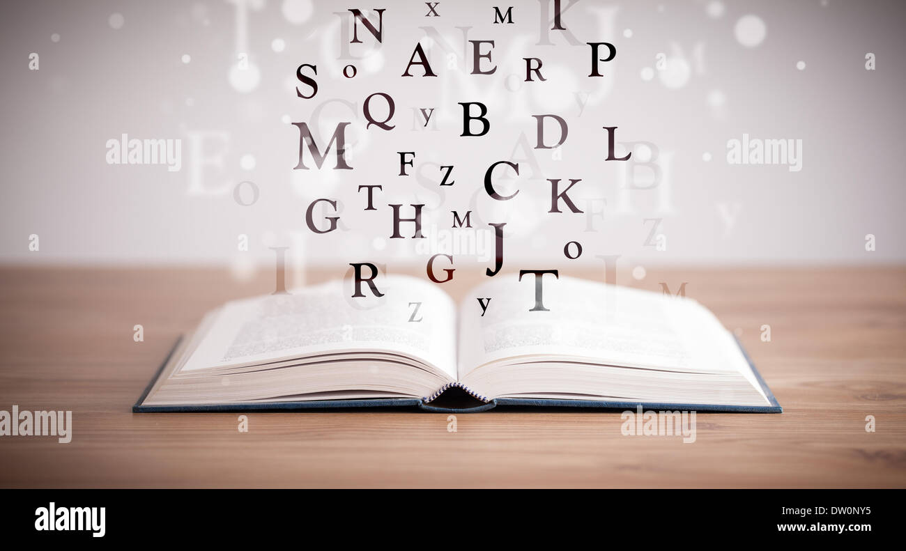 Opened book with flying letters Stock Photo - Alamy
