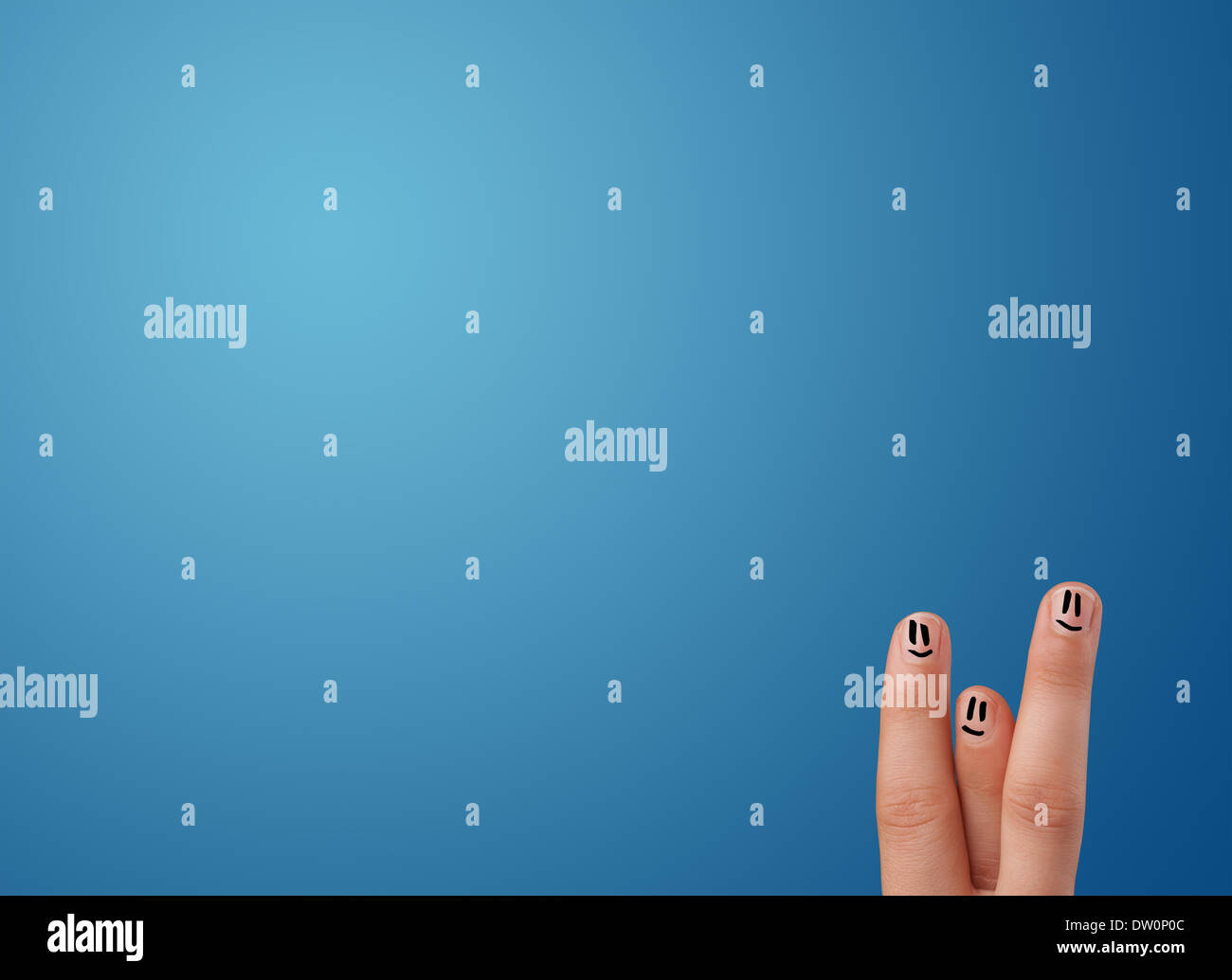 Happy smiley face fingers looking at empty blue background copy space ...