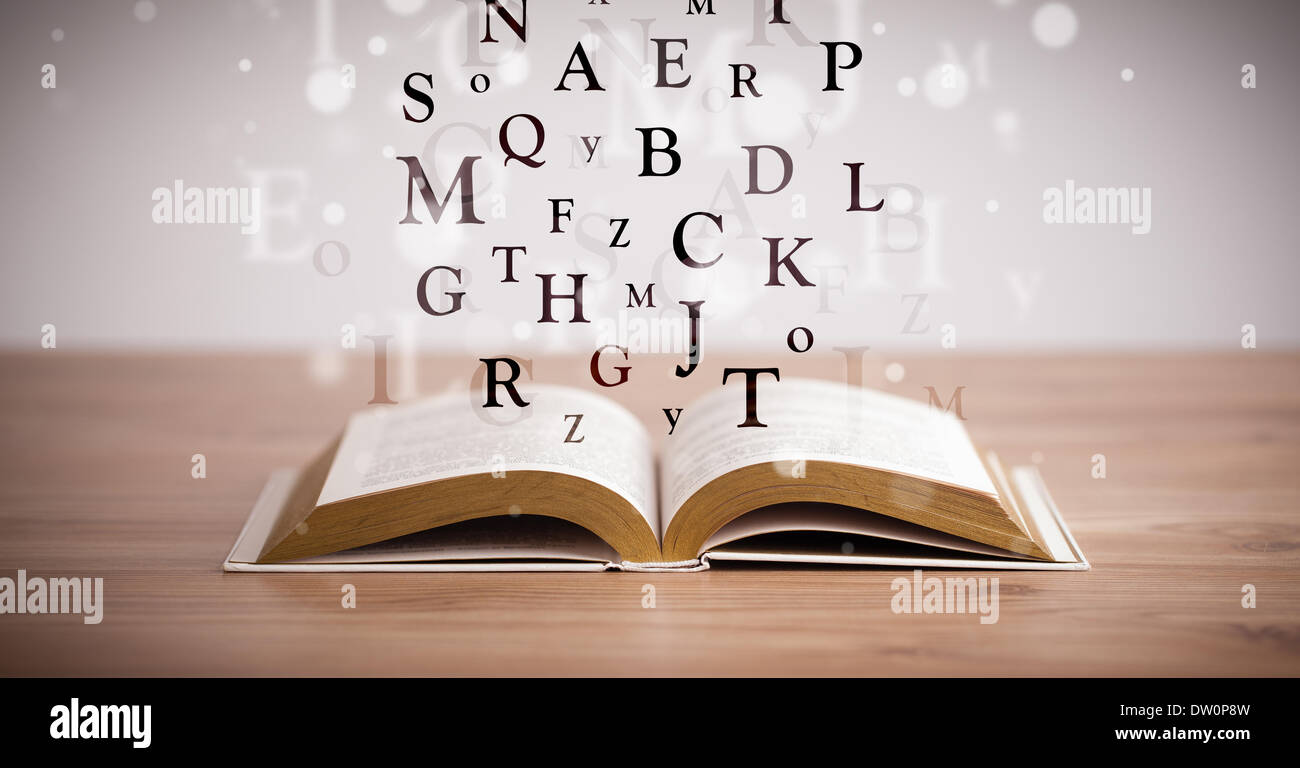 Opened book with flying letters Stock Photo - Alamy
