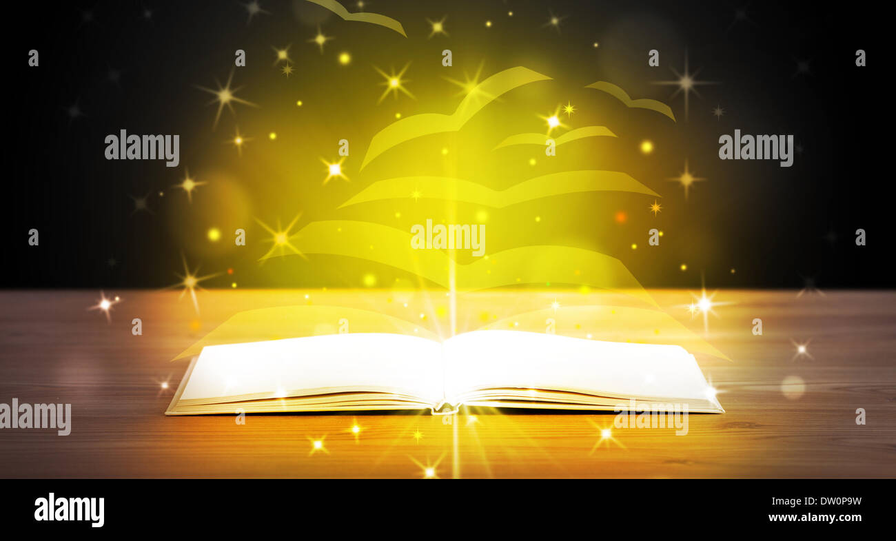 Open book with golden glow flying paper pages Stock Photo - Alamy