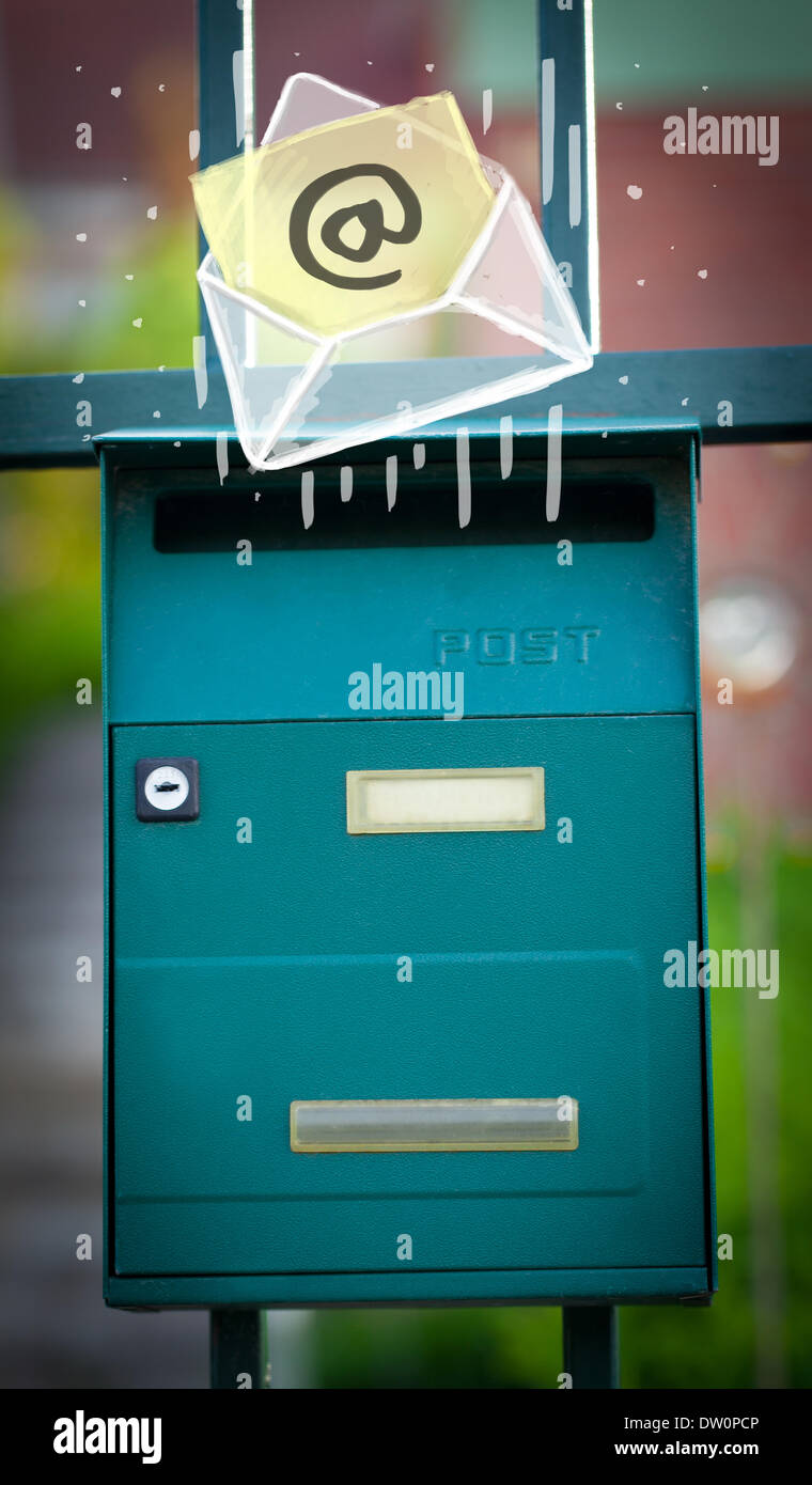 Envelope with email sign dropping into mailbox Stock Photo - Alamy