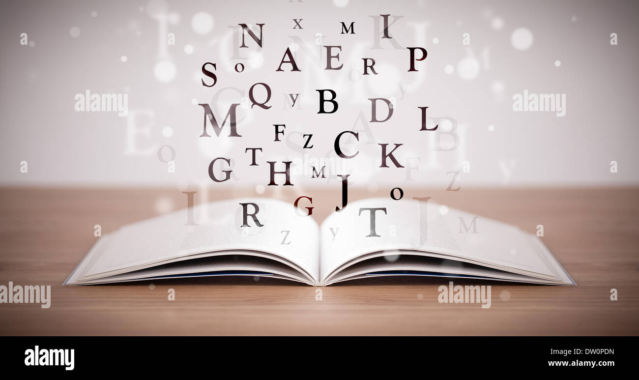 Opened book with flying letters Stock Photo - Alamy