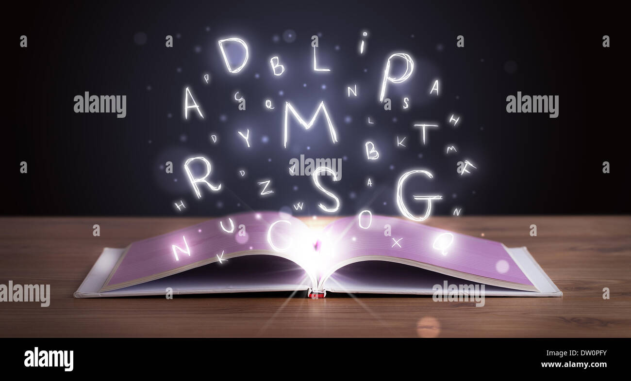 Open book with glowing letters flying out Stock Photo - Alamy
