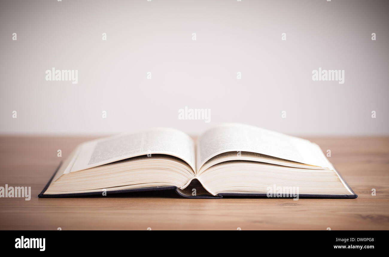 Open Book on wood background Stock Photo - Alamy