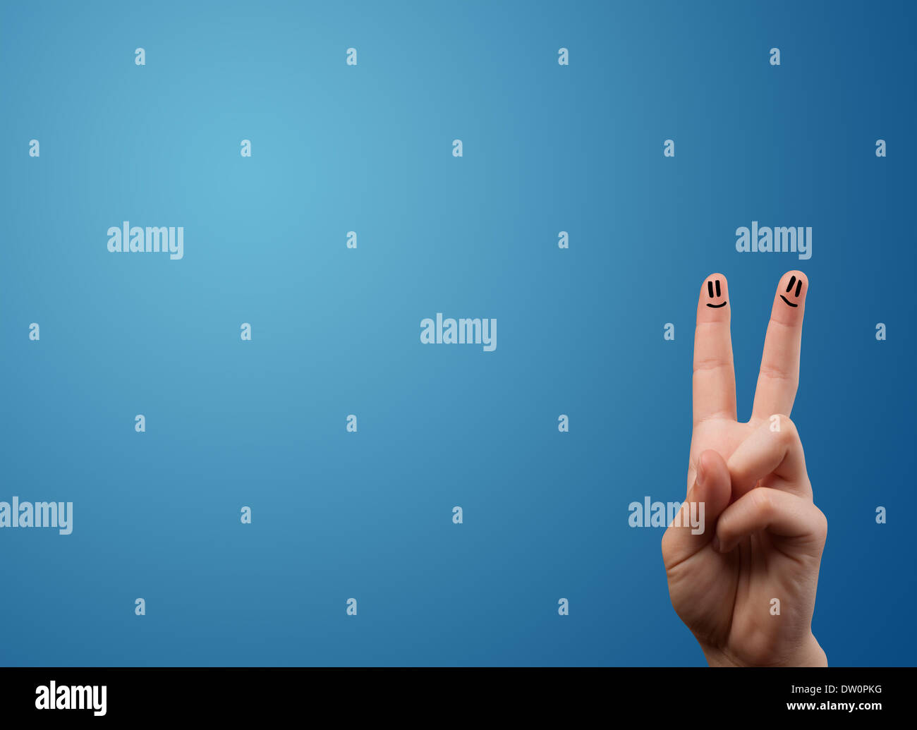 Happy smiley face fingers looking at empty blue background copy space ...