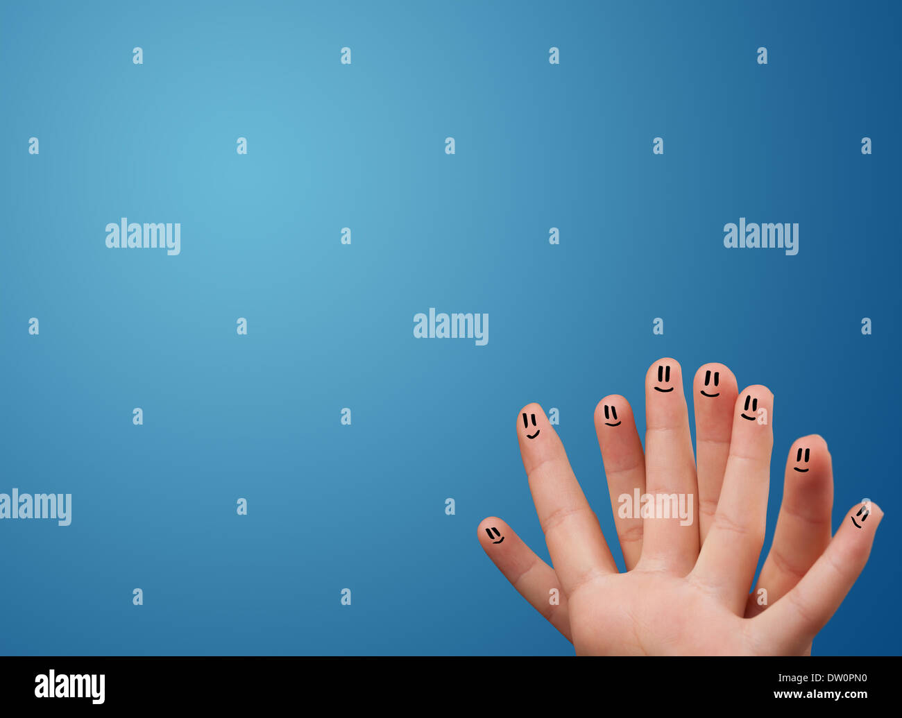 Happy smiley face fingers looking at empty blue background copy space ...
