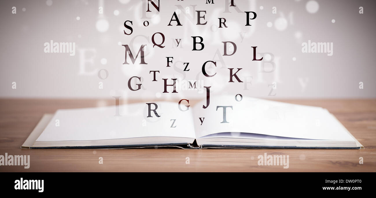 Opened book with flying letters Stock Photo - Alamy