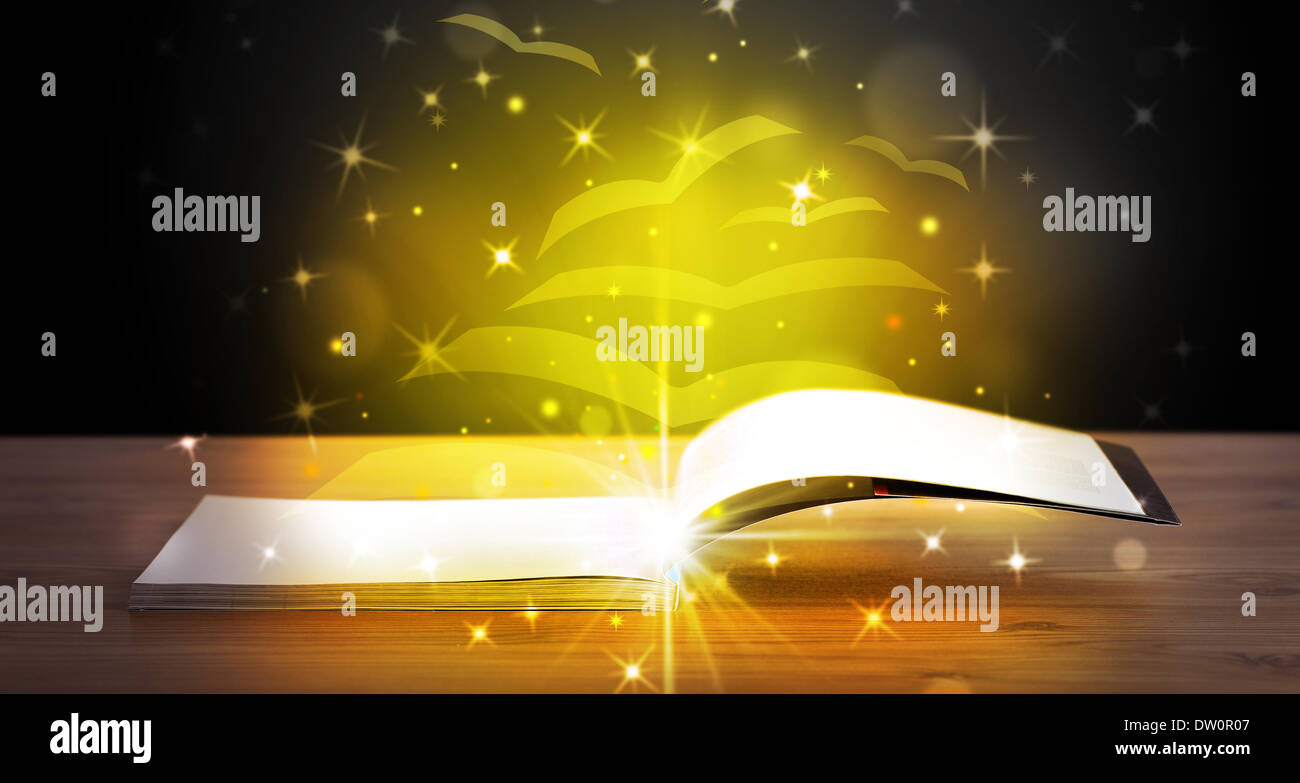 Open book with golden glow flying paper pages Stock Photo - Alamy