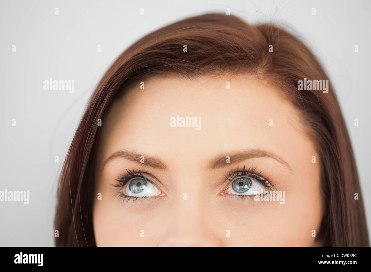 Thinking girl looking up Stock Photo - Alamy