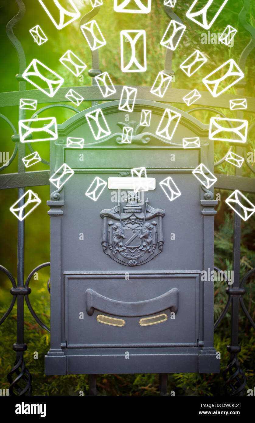 Mailbox with letter icons on glowing green background Stock Photo - Alamy