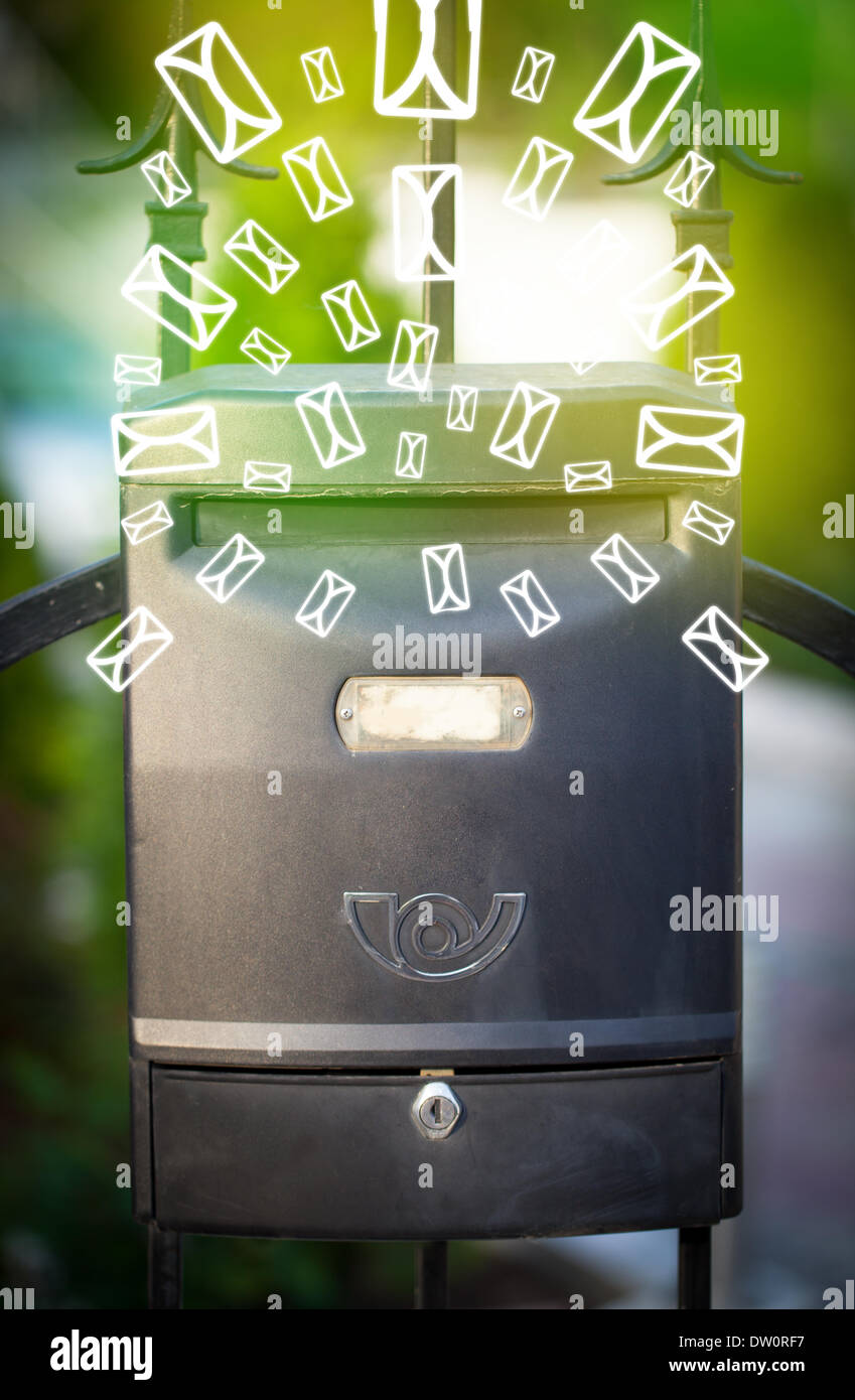 Mailbox with letter icons on glowing green background Stock Photo - Alamy