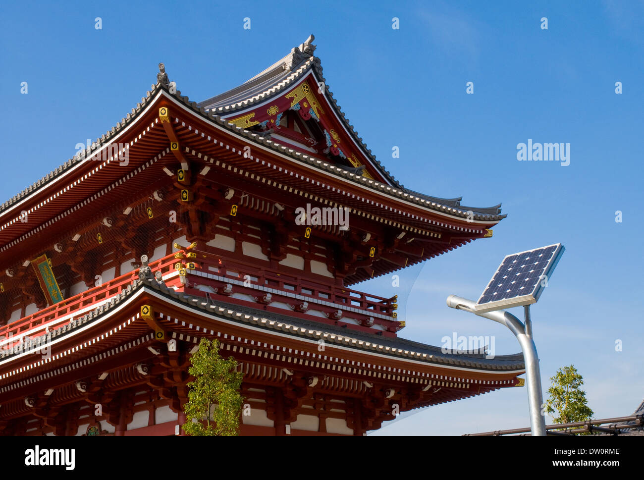 A modern solar panel contrasts a historic temple building at the ...