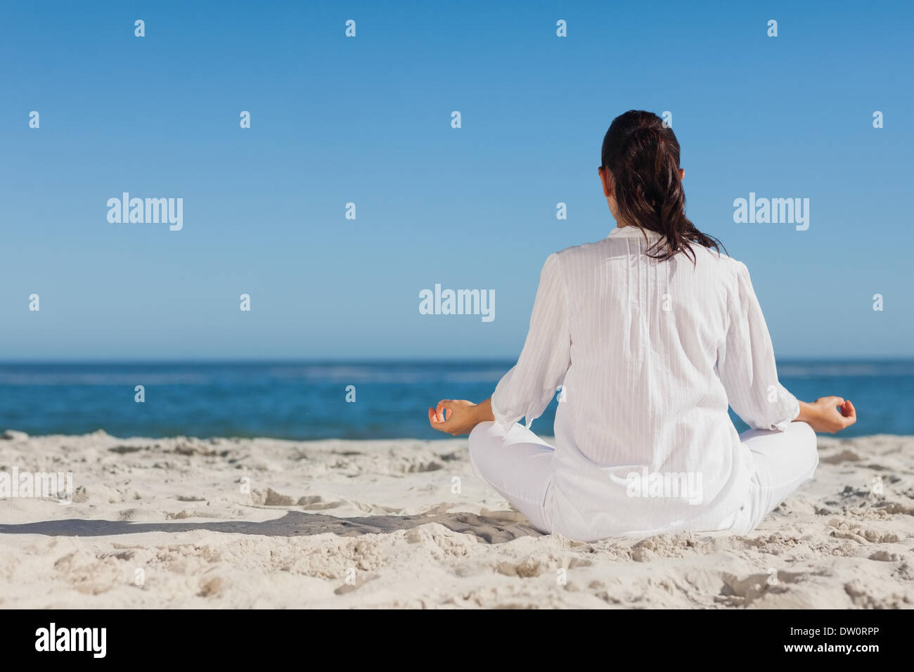 Woman doing yoga sitting back to camera Stock Photo - Alamy