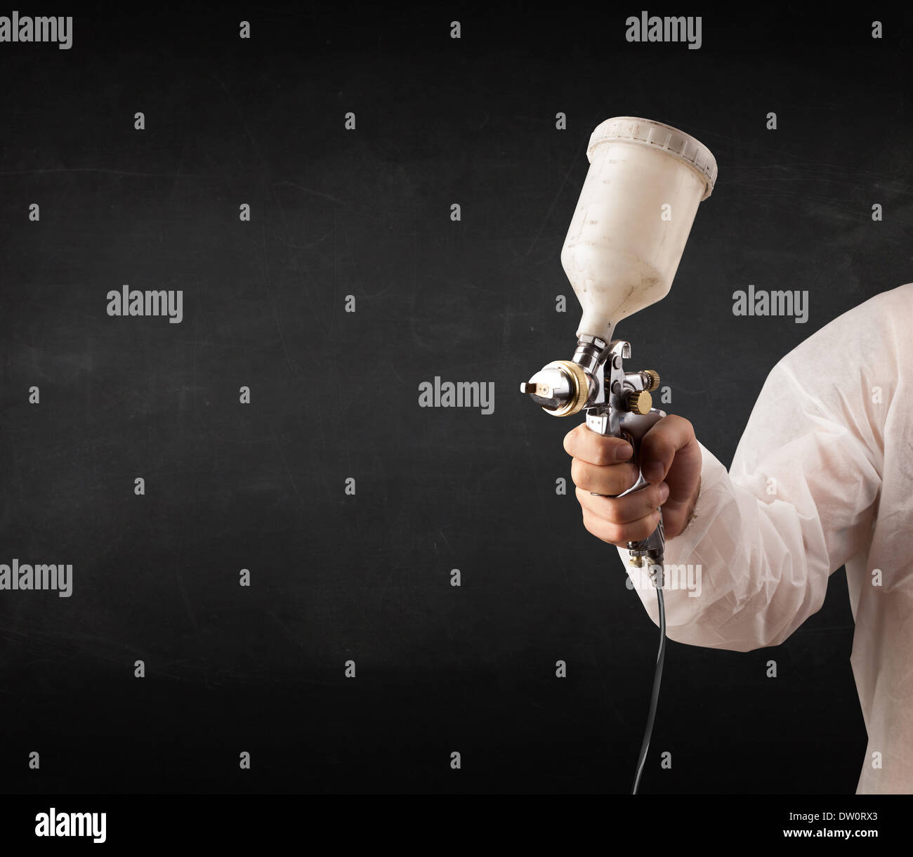Painter works with airbrush gun and empty copyspace Stock Photo - Alamy