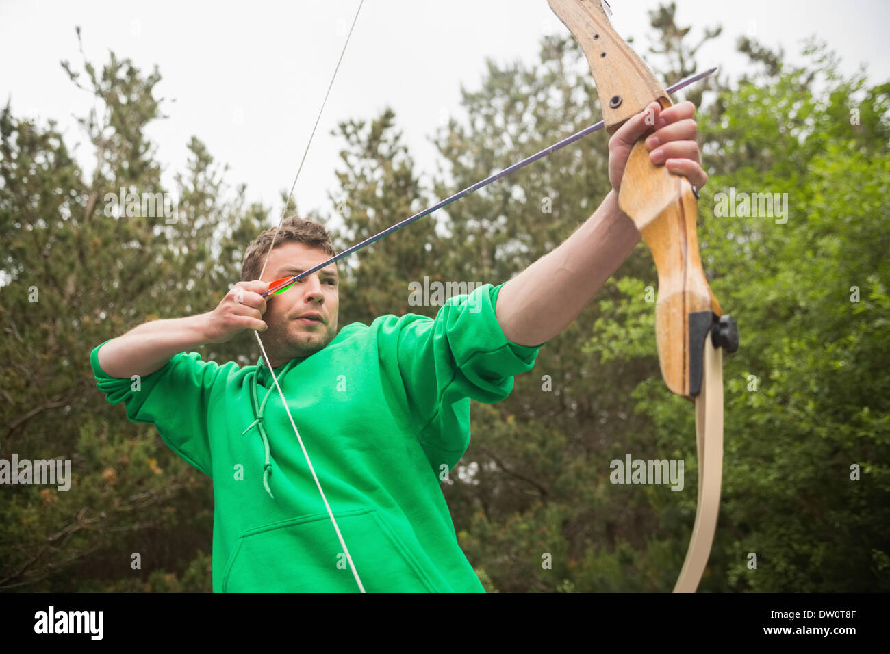 Concentrating man practicing archery Stock Photo - Alamy
