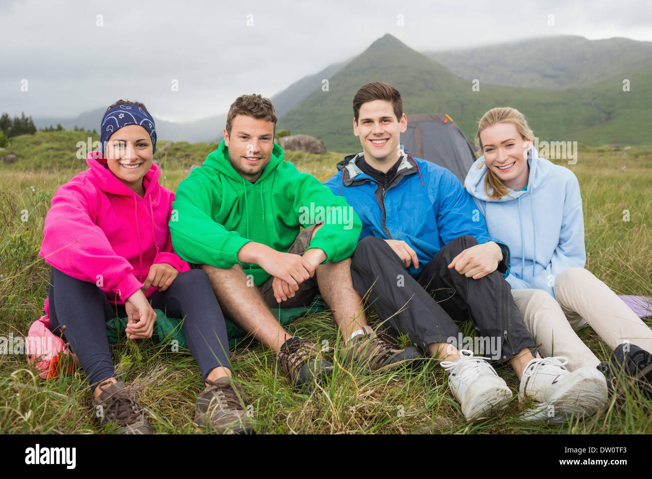 Friends sitting outside on a camping trip Stock Photo - Alamy