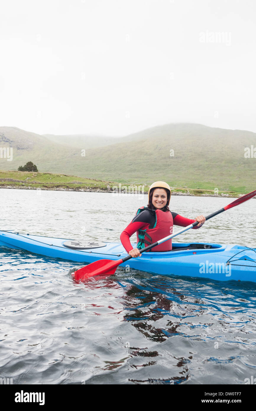 Happy woman in a kayak Stock Photo - Alamy