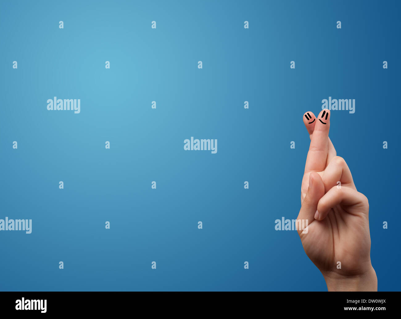 Happy smiley face fingers looking at empty blue background copy space ...