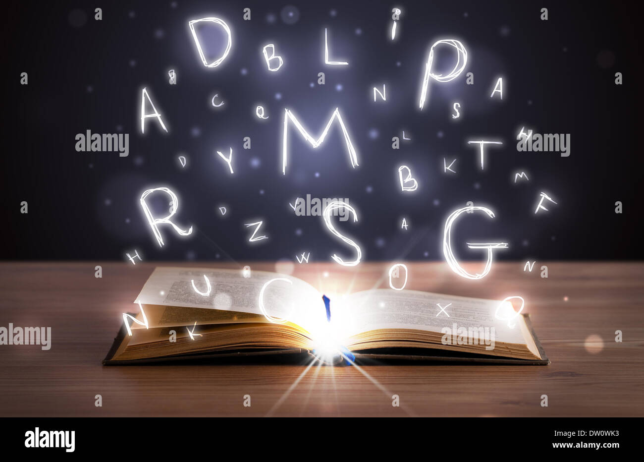 Open book with glowing letters flying out Stock Photo - Alamy