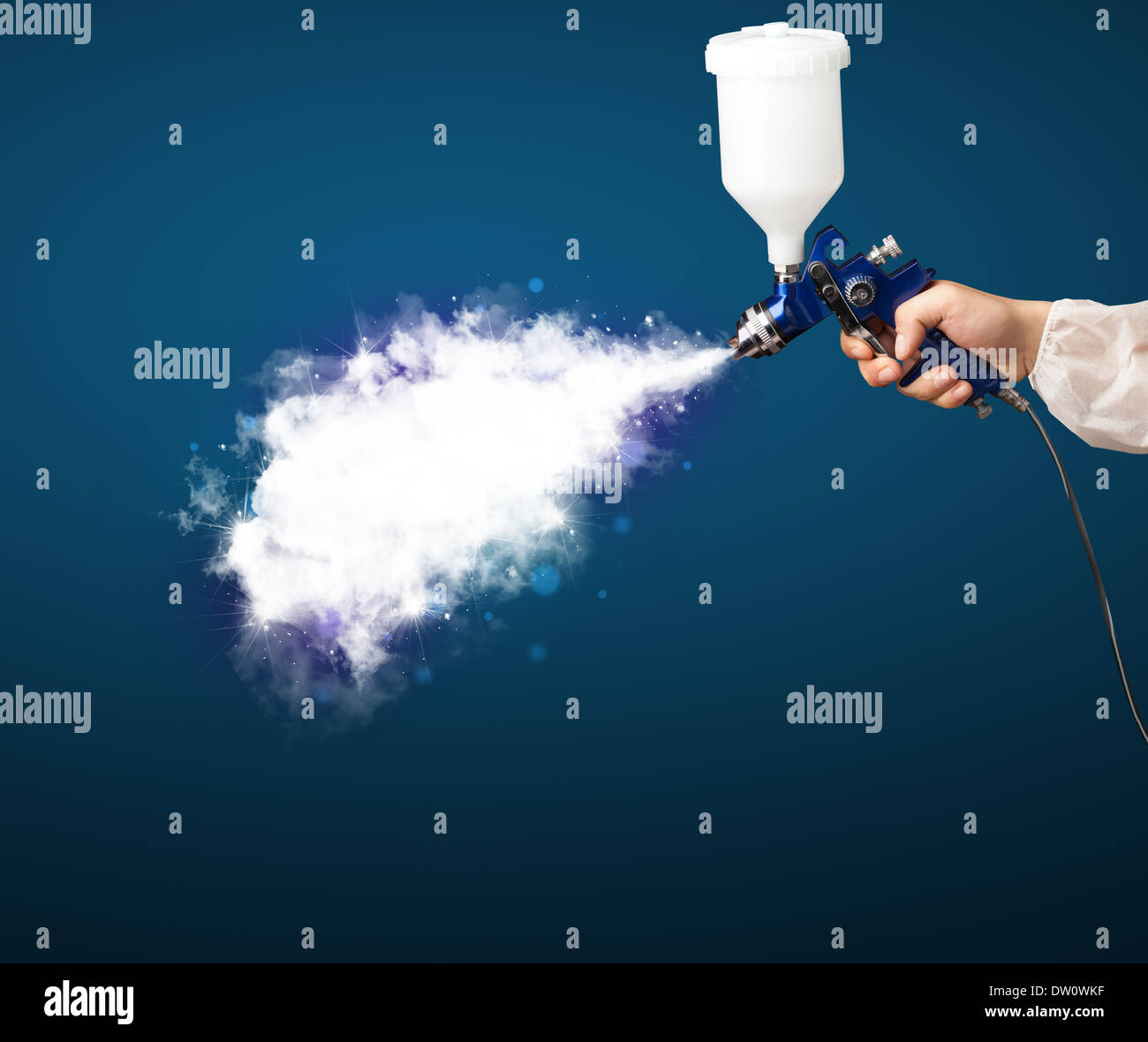 Painter with airbrush gun and white magical smoke Stock Photo - Alamy