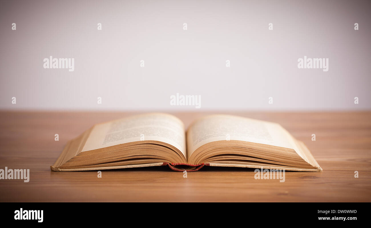 Open Book on wood background Stock Photo - Alamy