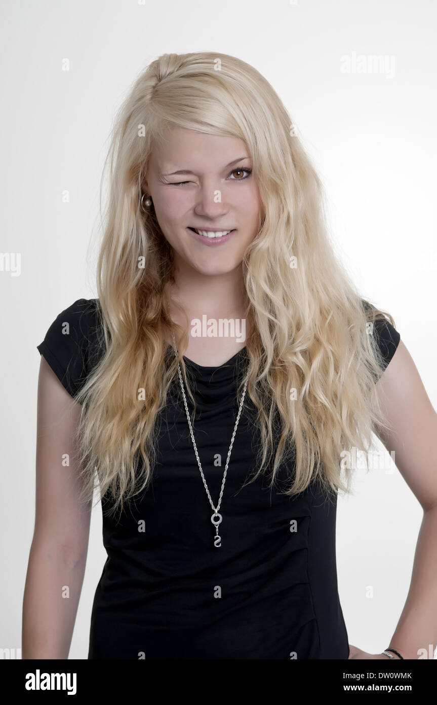 young woman winking with one eye Stock Photo - Alamy