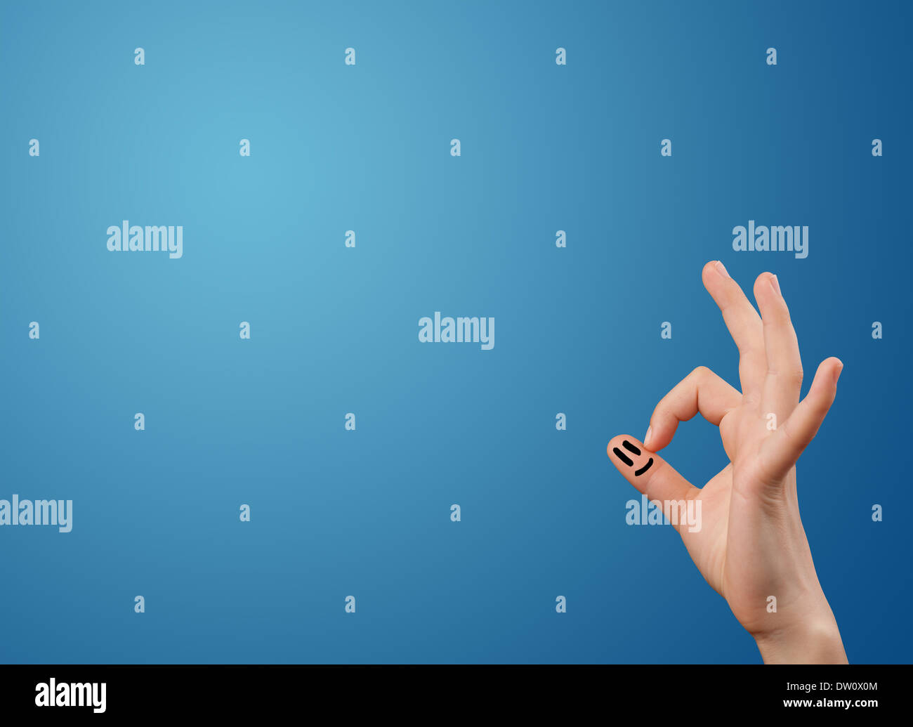 Happy smiley face fingers looking at empty blue background copy space ...