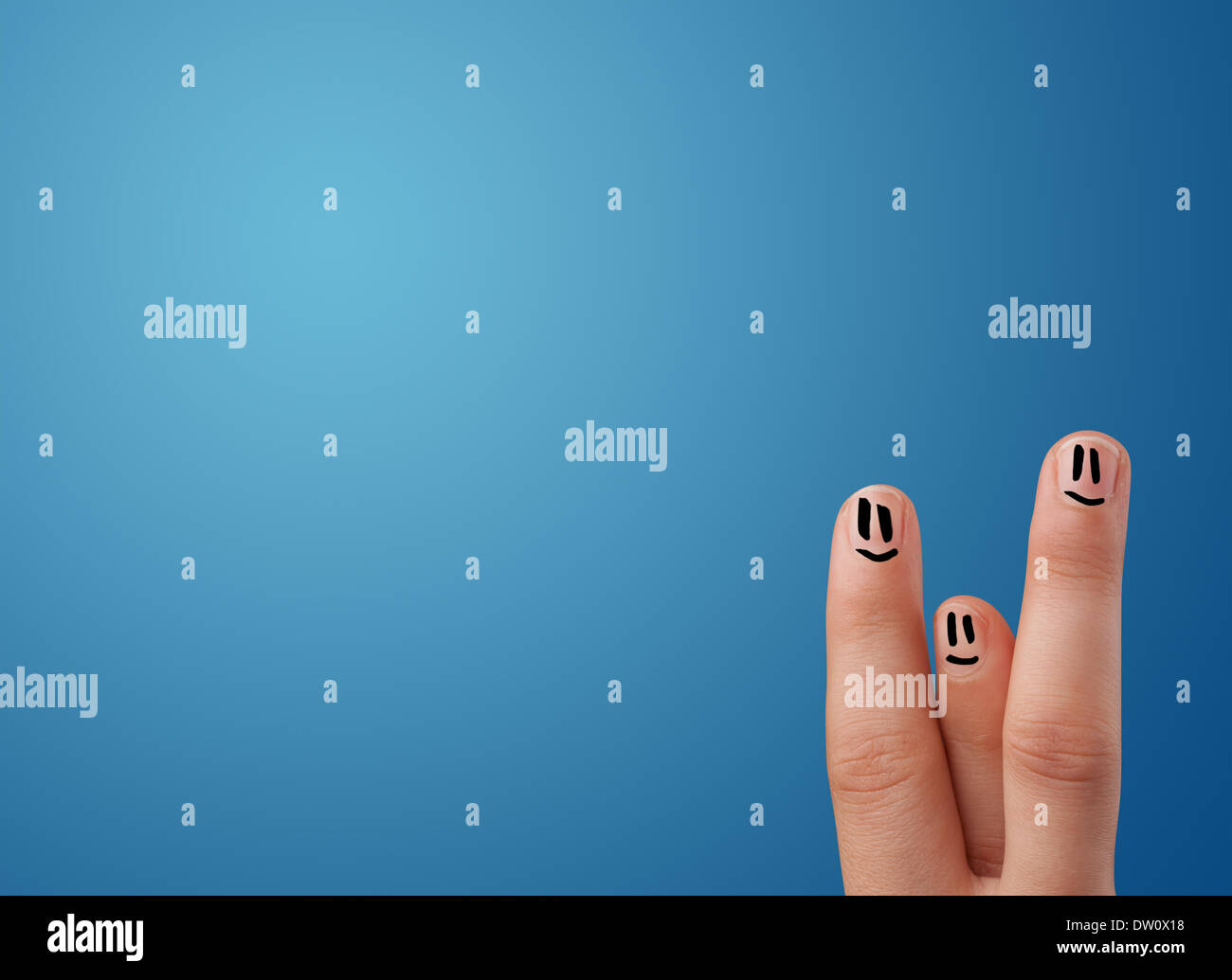 Happy smiley face fingers looking at empty blue background copy space ...