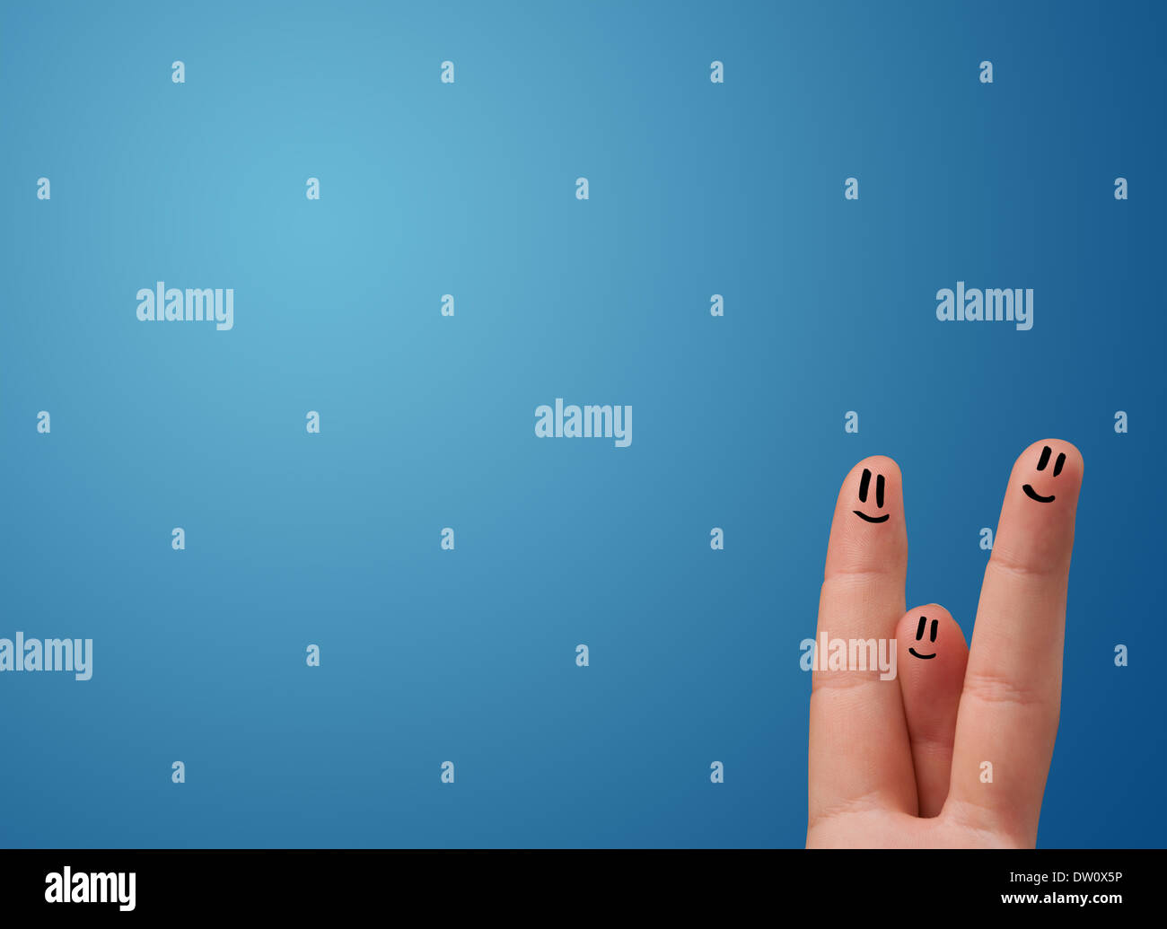 Happy smiley face fingers looking at empty blue background copy space ...