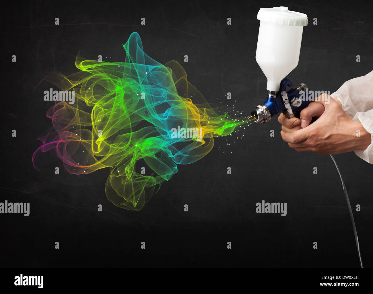 Painter working with airbrush and paints colorful paint Stock Photo - Alamy