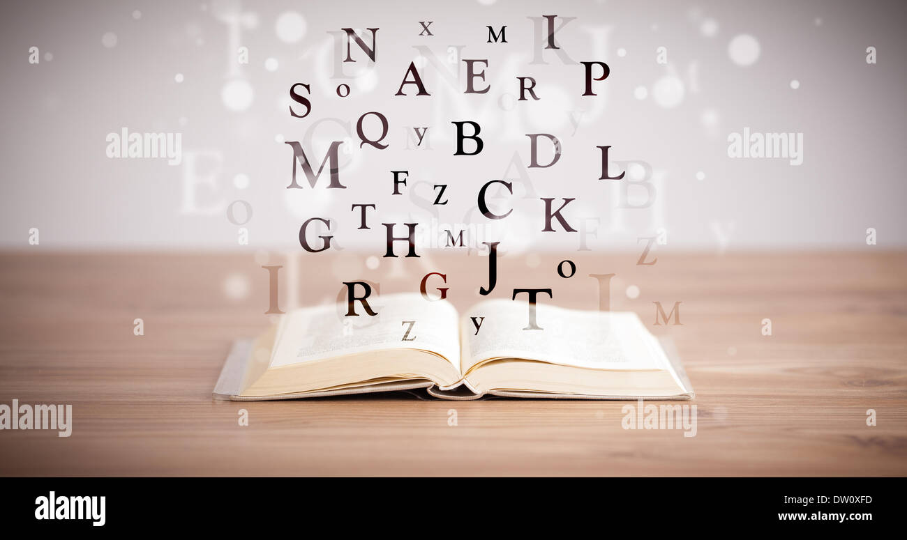 Opened book with flying letters Stock Photo - Alamy