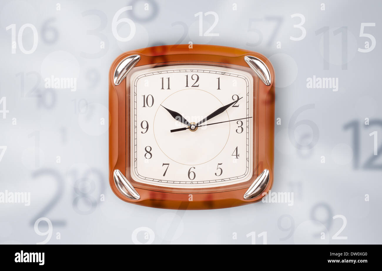 Modern clock with numbers comming out Stock Photo - Alamy