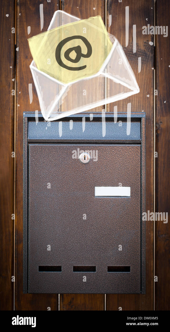 Envelope with email sign dropping into mailbox Stock Photo - Alamy