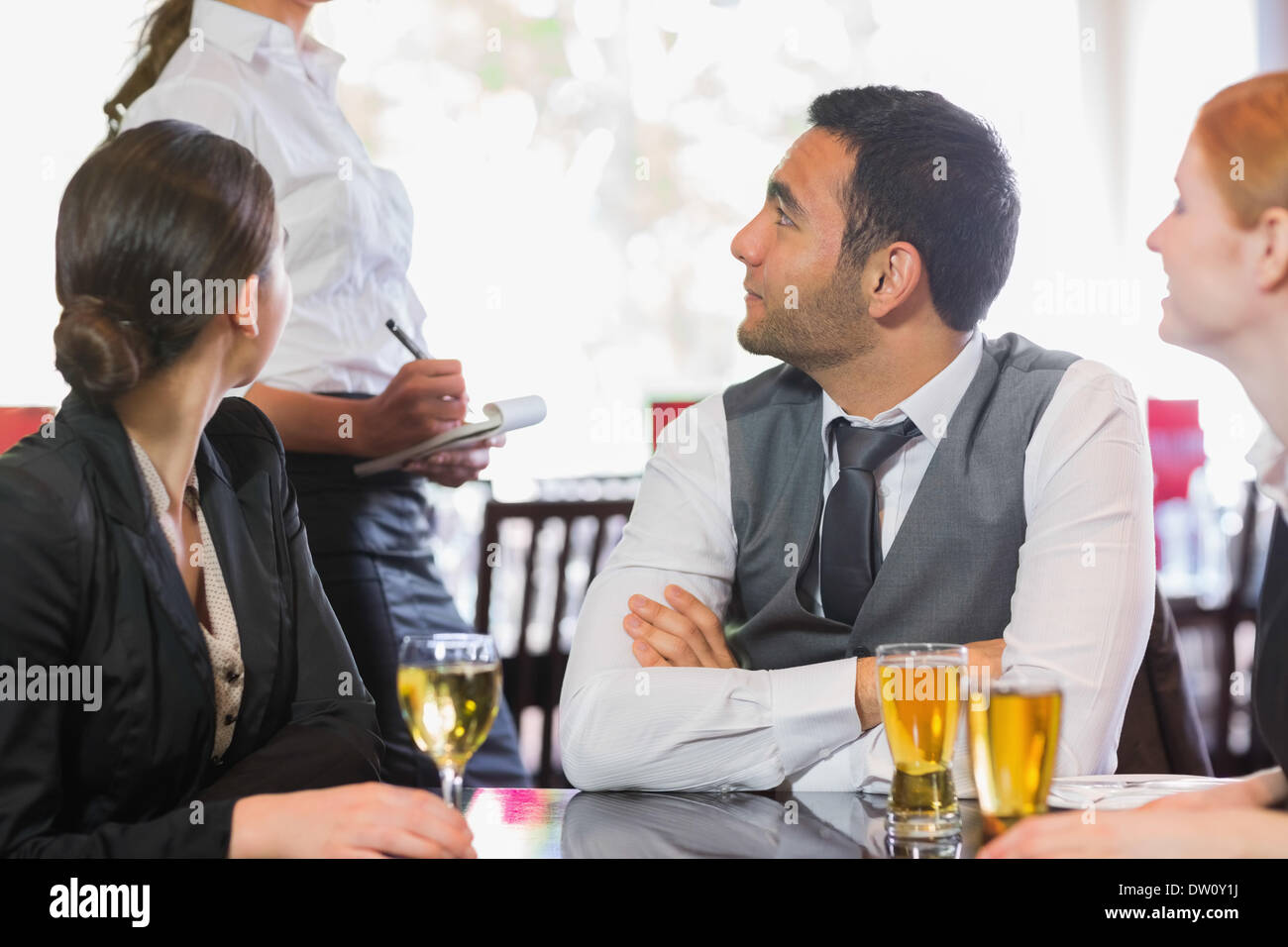 Business people talking to the waiter Stock Photo - Alamy
