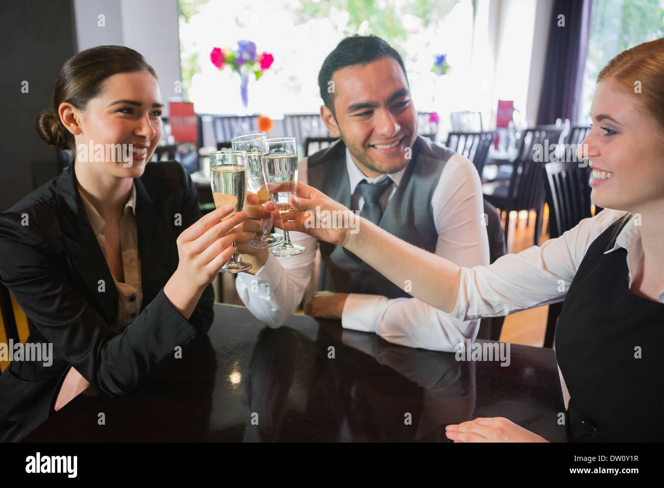 Three business people toasting their success Stock Photo - Alamy