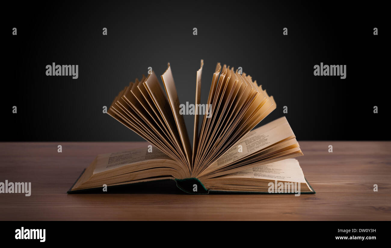 Open book on wooden deck Stock Photo - Alamy