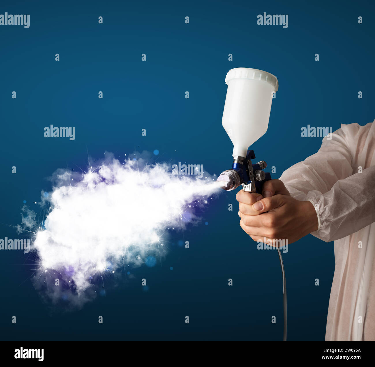 Painter with airbrush gun and white magical smoke Stock Photo - Alamy