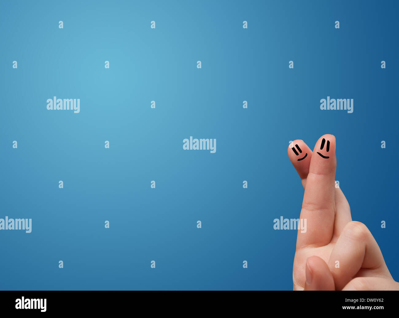 Happy smiley face fingers looking at empty blue background copy space ...