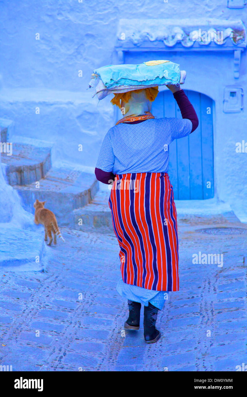 Woman In Traditional Clothing Carrying A Tray of Bread Dough ...