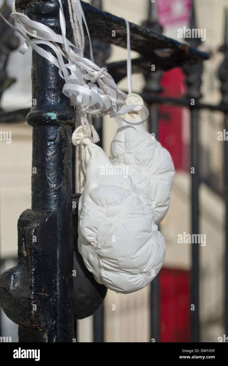 White rubber balloon tied to railings Stock Photo - Alamy