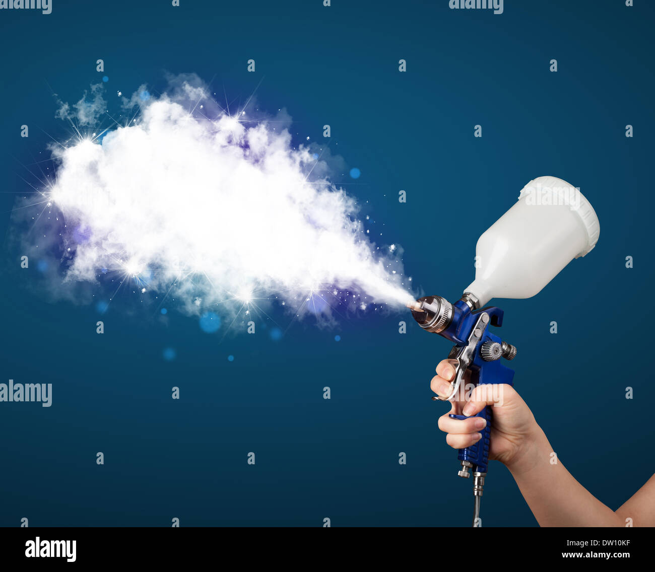 Painter with airbrush gun and white magical smoke Stock Photo - Alamy