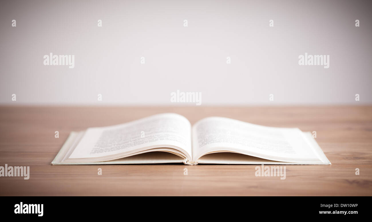 Open Book on wood background Stock Photo - Alamy