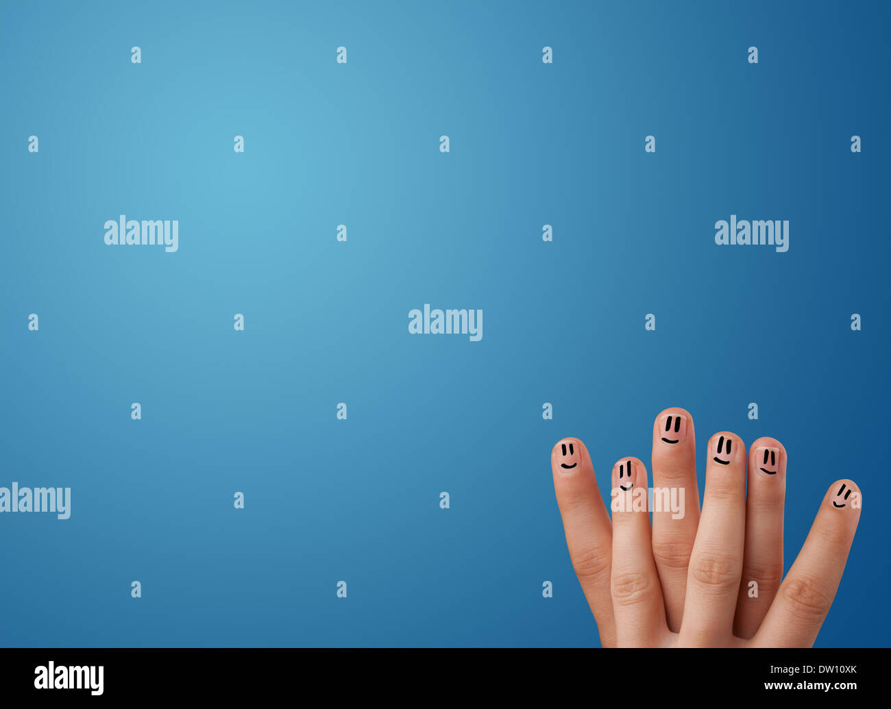 Happy smiley face fingers looking at empty blue background copy space ...