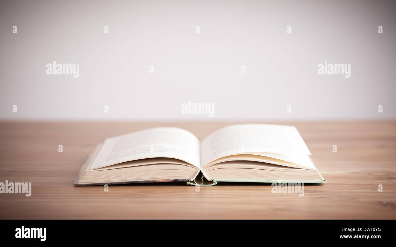 Open Book on wood background Stock Photo - Alamy