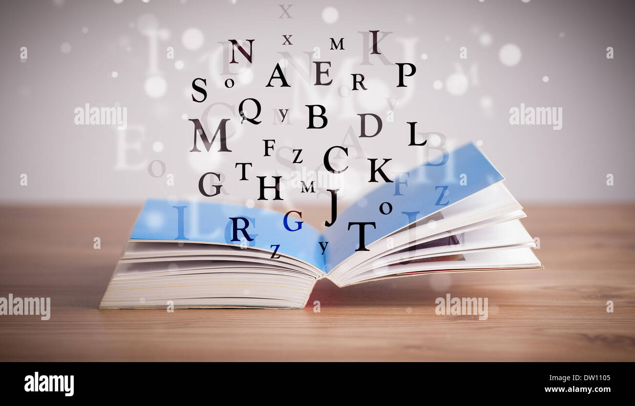 Opened book with flying letters Stock Photo - Alamy