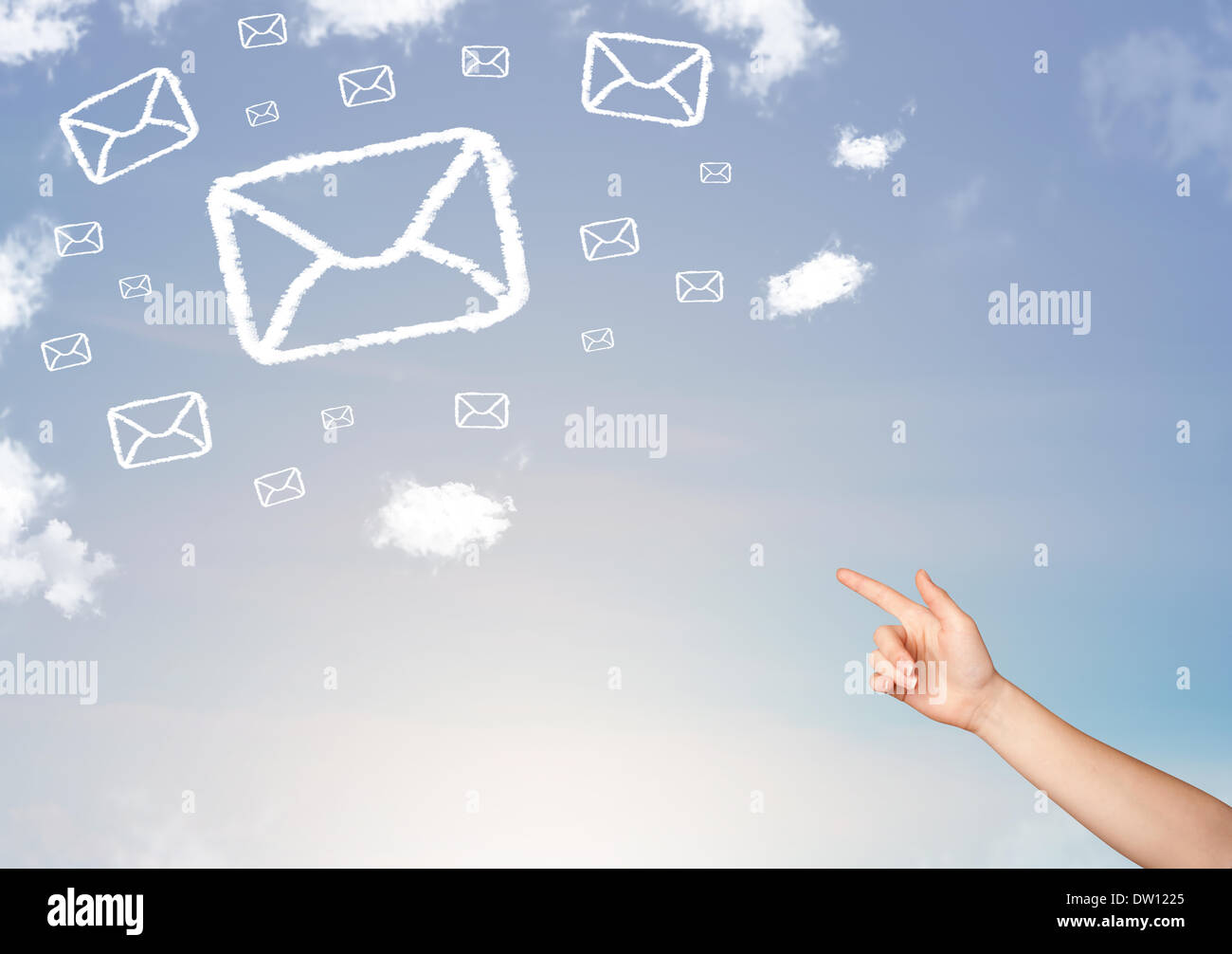 Hand pointing at mail symbol clouds on blue sky Stock Photo - Alamy