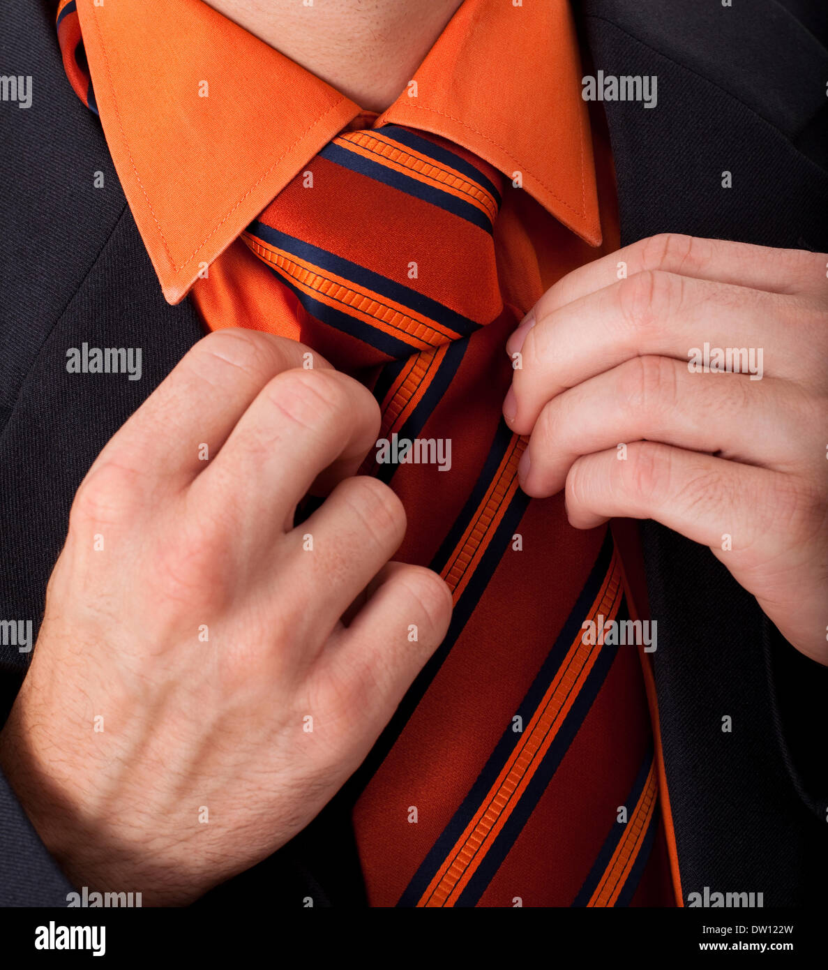 Detail of a man, fixing his tie Stock Photo - Alamy
