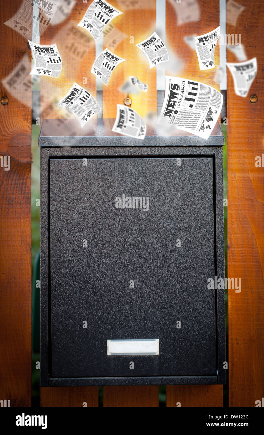 Post box with daily newspapers flying Stock Photo - Alamy