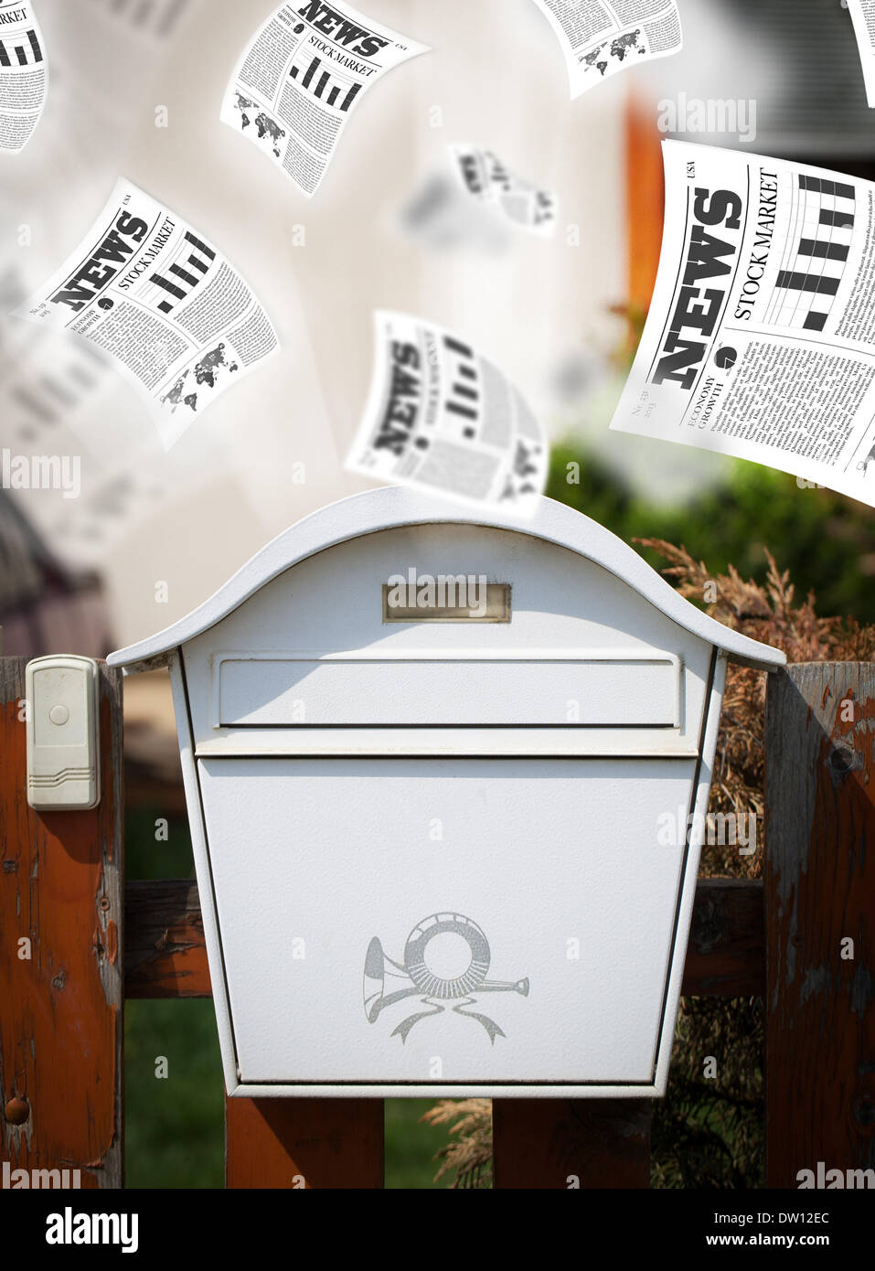 Post box with daily newspapers flying Stock Photo - Alamy